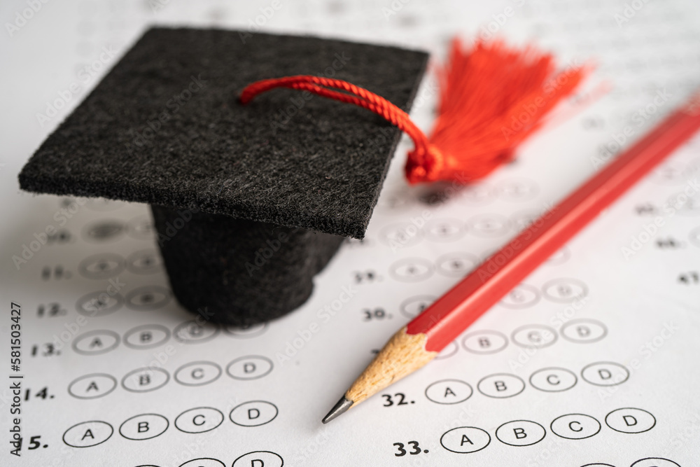 Graduation gap hat and pencil on answer sheet background, Education ...