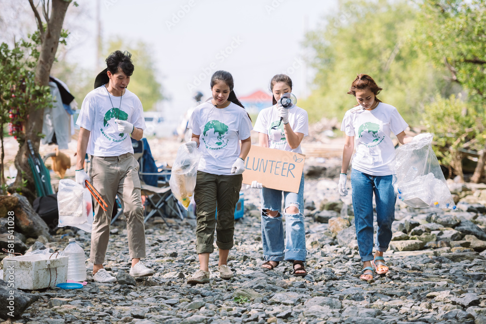Volunteering people help to picking plastic and foam garbage on park ...