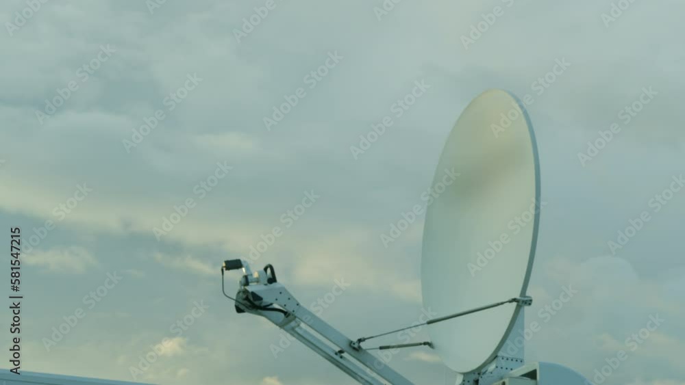 SNG vehicles for TV broadcasting with round white satellite on roof ...