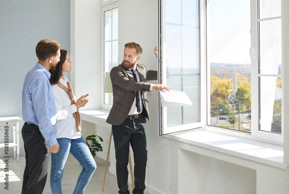 Real estate agent shows new home. Male realtor shows apartment for sale ...