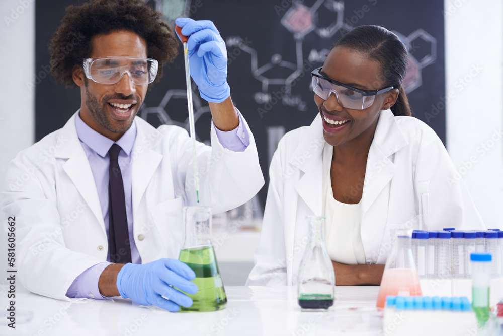 Chemical fun. two scientists conducting an experiment with various ...