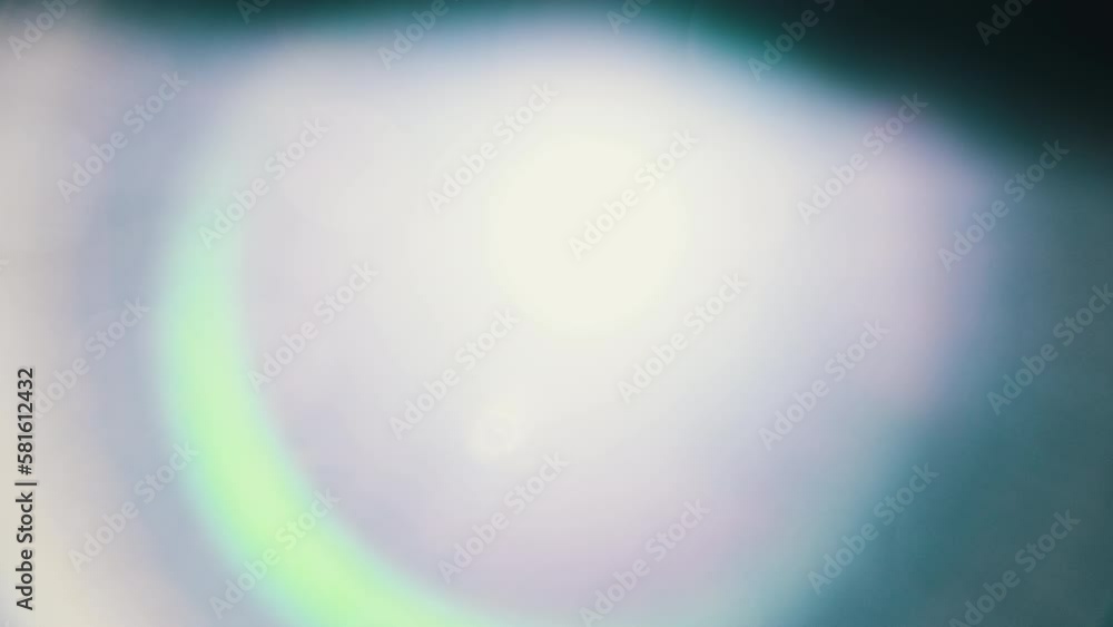 The light of a flashlight into the camera on a black background. Light ...