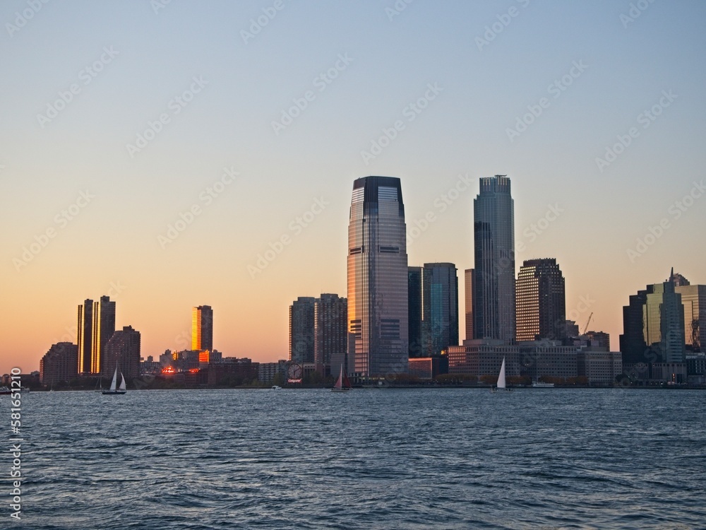 The high rises of Jersey City tower over the Hudson River at dusk Stock ...