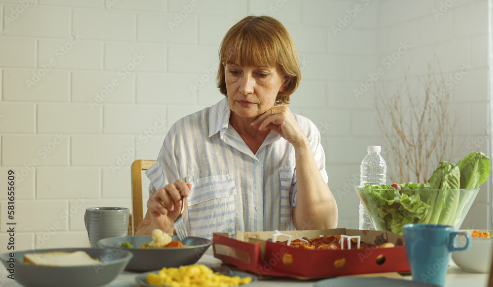 Elderly retired grandmother stay at home with unhappy face sitting ...