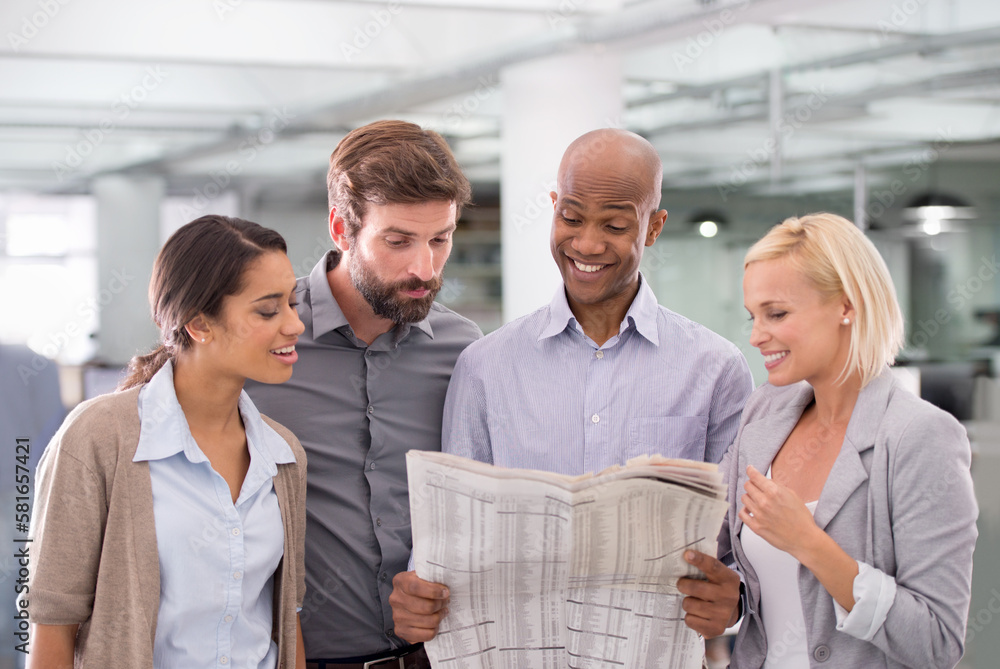 Wow Weve gone up. a group of work colleagues reading a newspaper. Stock ...