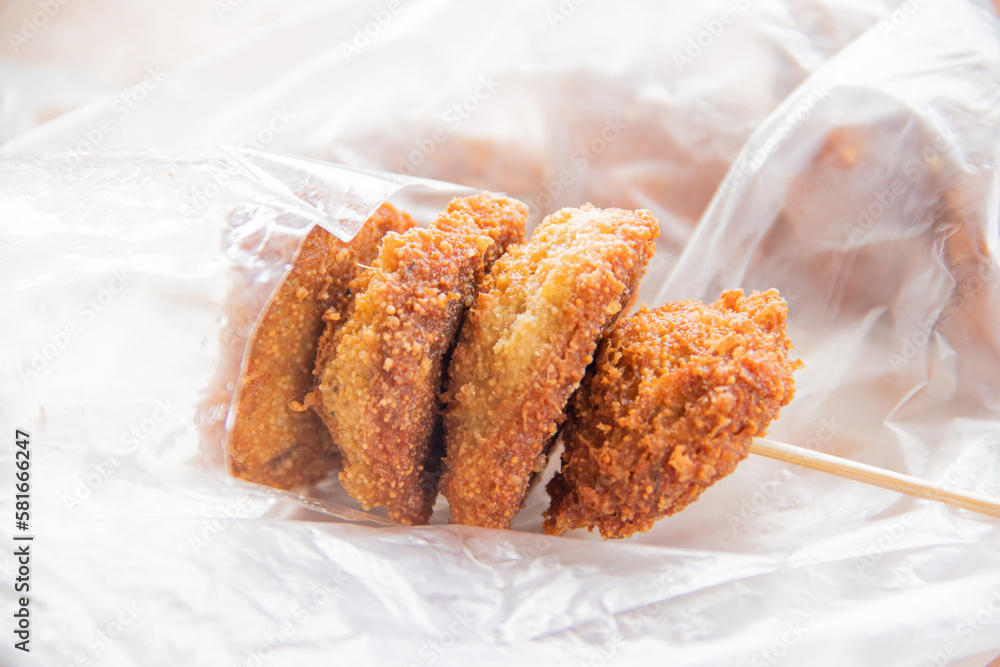 Four fried fish roe The skewers are in a plastic bag. Made from carp ...