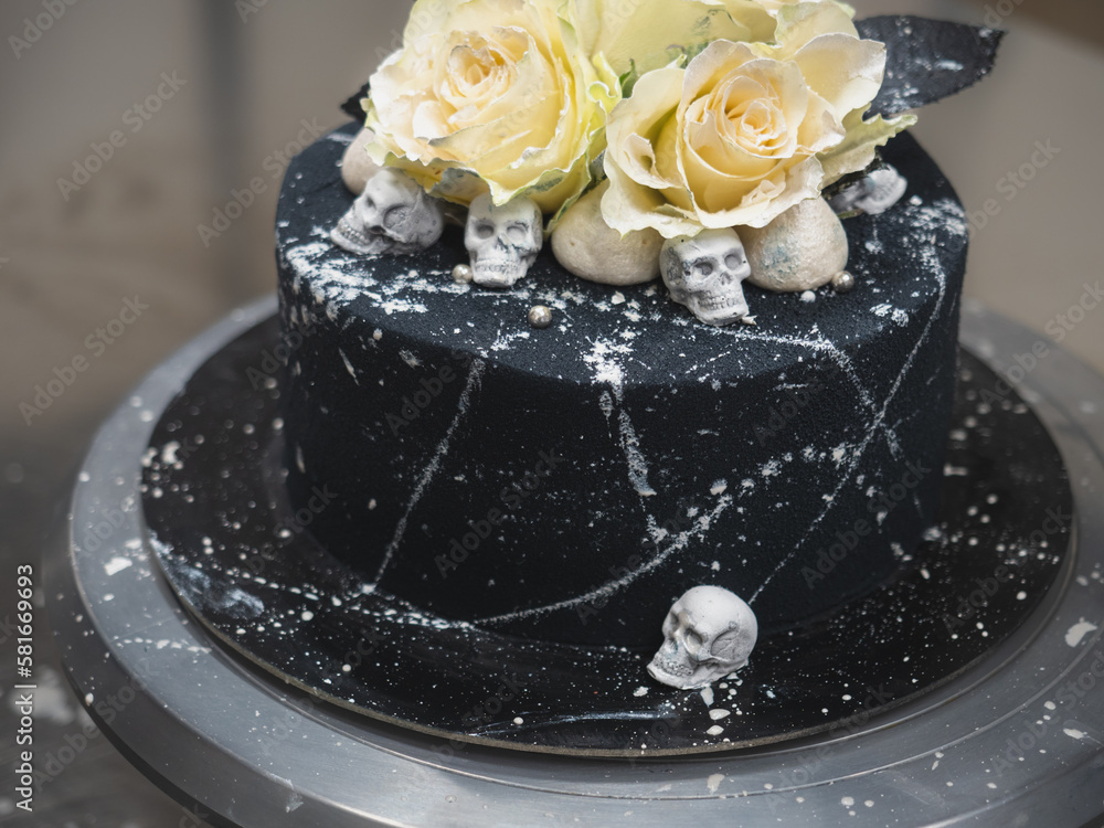 chef topping black airbrush painted frosted icing cake on top two real ...