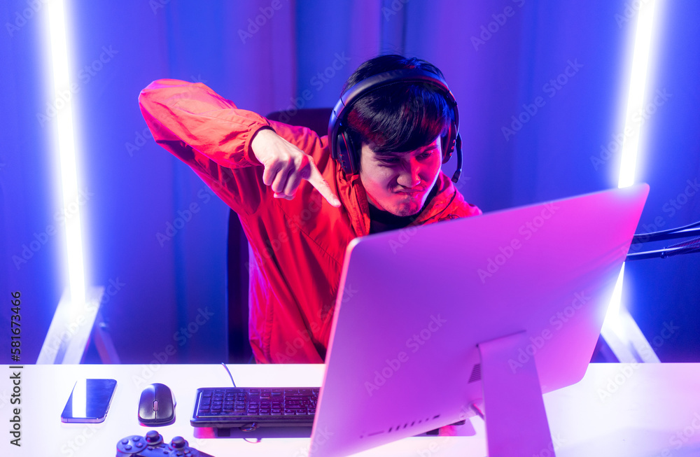 Angry asian gamer man playing computer pc. He lose in the game. Missed ...