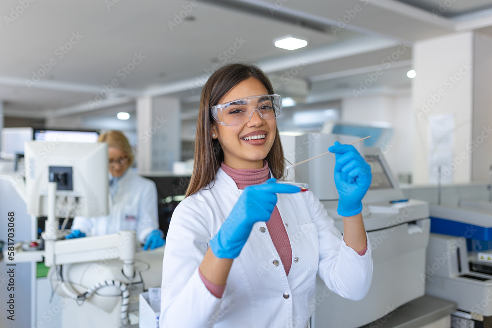 Petri dish in hand of young scientist near microscope in laboratory ...