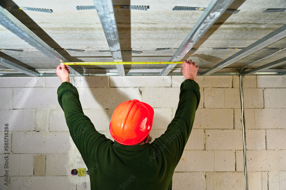 Construction worker building construction for plasted board ceiling ...