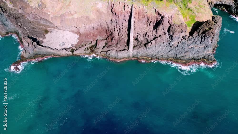 defined rocks and deep blue lapping ocean waves , slowly shaping the ...
