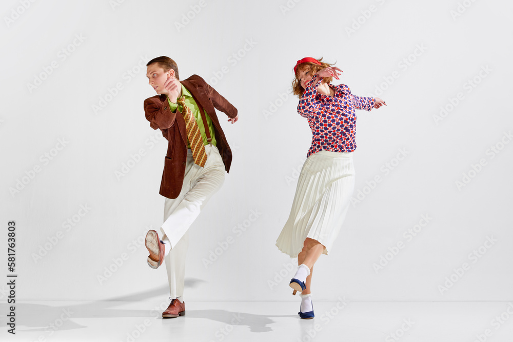 Boogie-woogie. Young man and woman in stylish clothes dancing retro ...