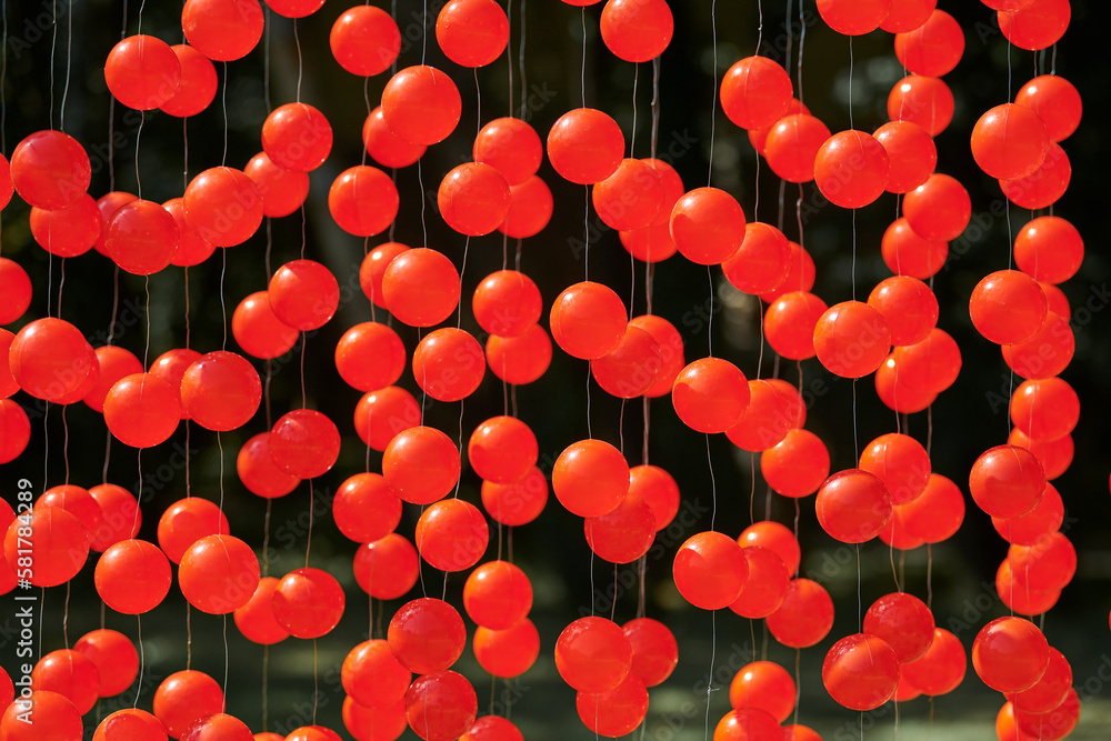 Red balls suspended on wire, outdoor art object symbolizing blood cells ...
