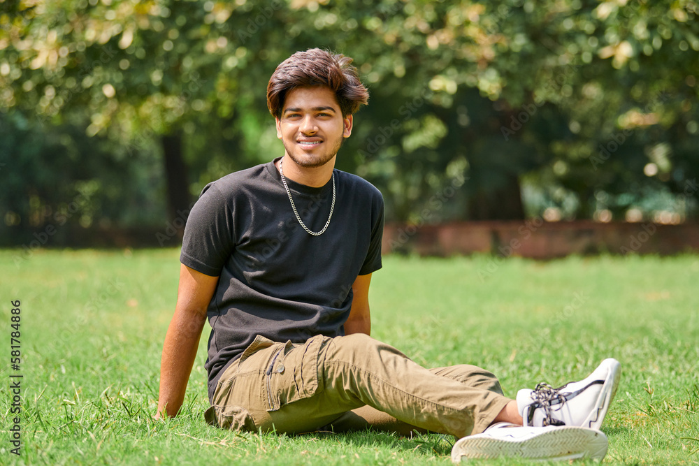 Smiling indian man candid portrait in black t shirt and silver neck ...