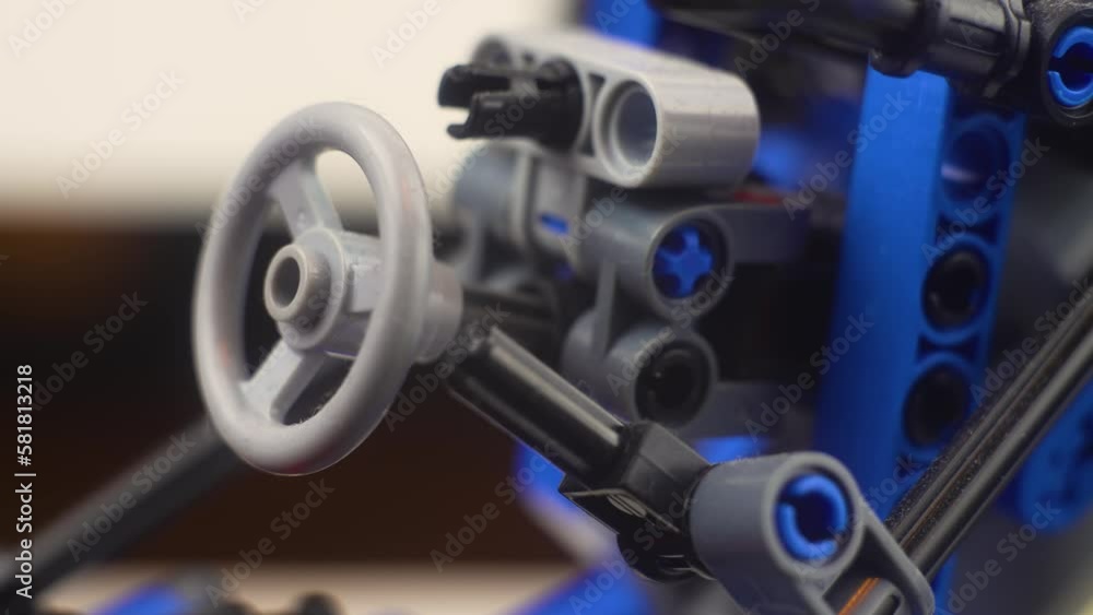 Macro demonstration of steering wheel rotates on chassis of toy car ...