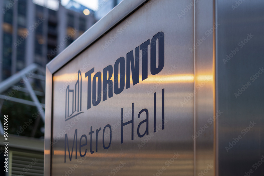 Shiny polished metal sign Toronto Metro Hall with the city logo symbol ...