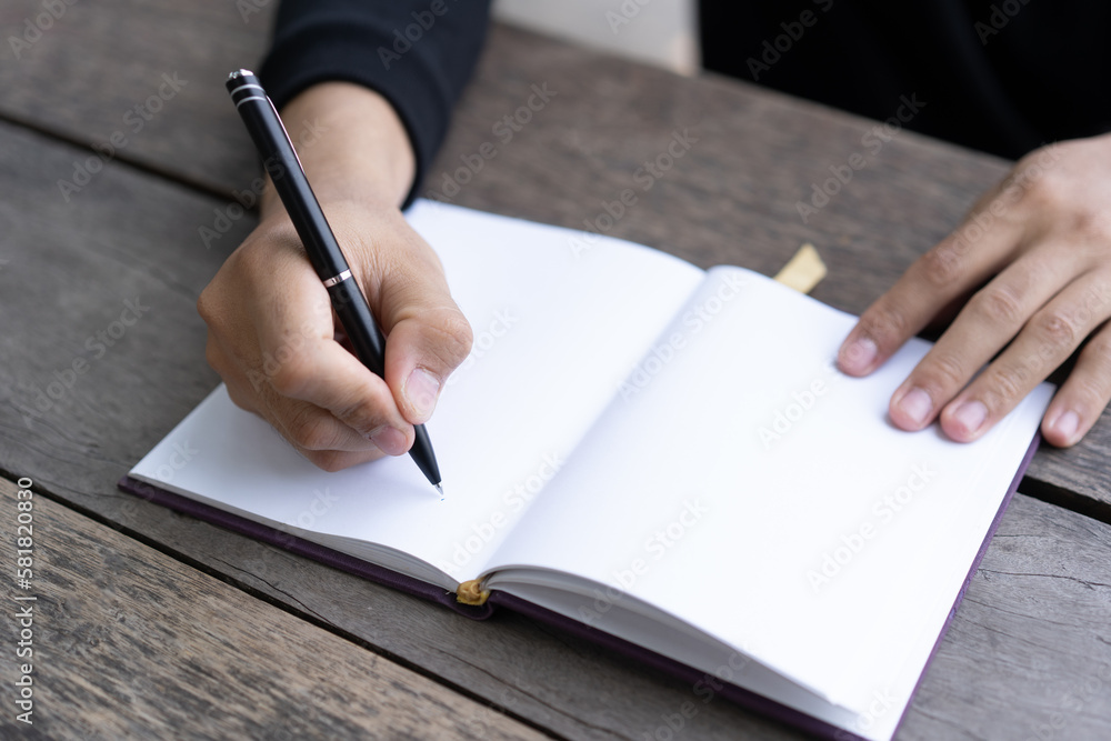 Asian young man spends holiday time writing diary, takes note in bullet ...