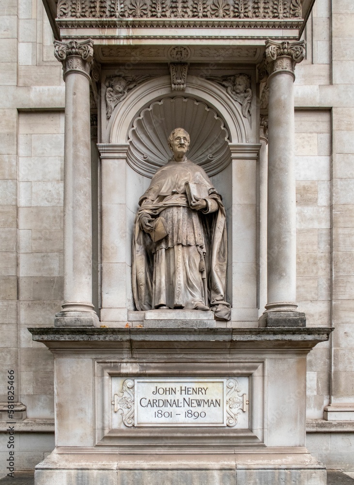 Vertical shot of a statue of John Henry Cardinal Newman outside the ...