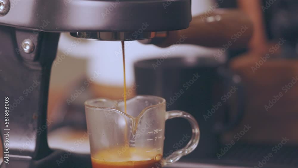 Close up slow motion 4K of beautiful coffee liquid flowing from coffee ...