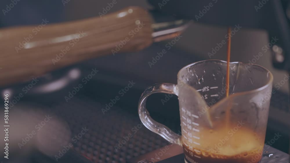 Close up slow motion 4K of beautiful coffee liquid flowing from coffee ...