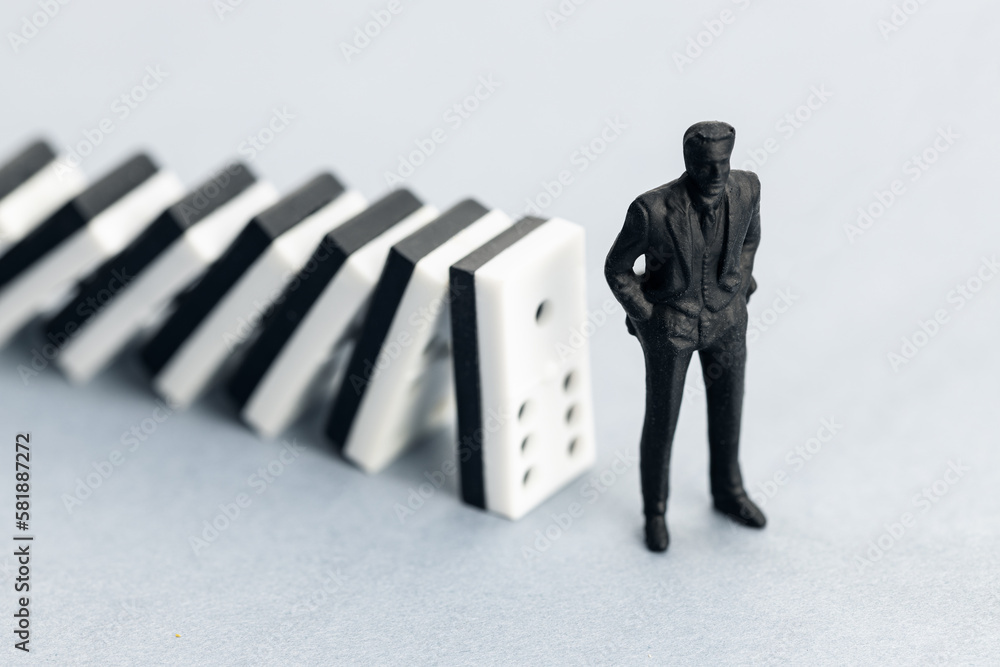 Domino effect concept. Dominoes falling and putting a company or ...
