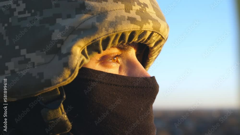 Gaze of male ukrainian army soldier in helmet and balaclava outdoor ...