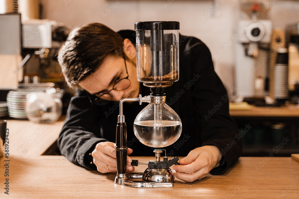 Barista is boil water in syphon device for alternative brewing coffee ...