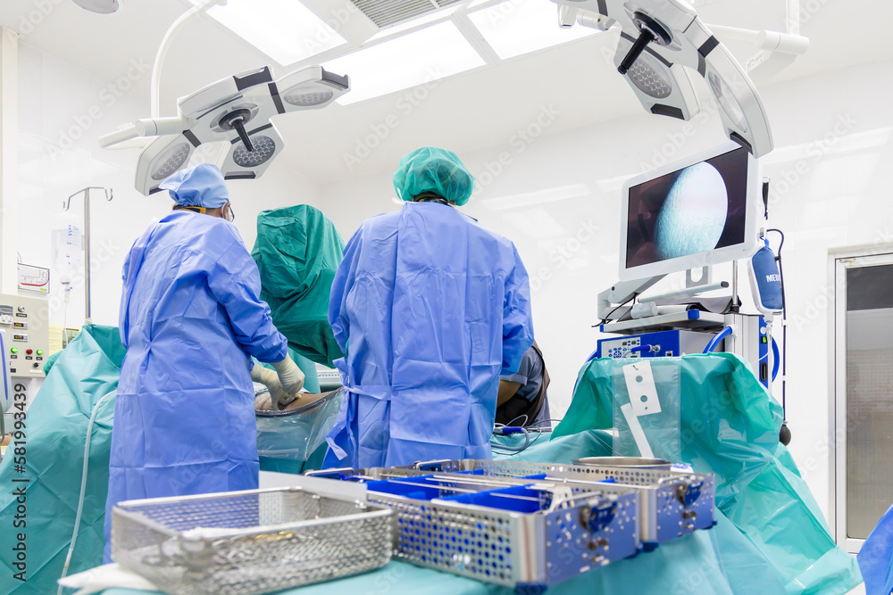 Doctor or surgeon in blue uniform did surgery inside operating room or ...