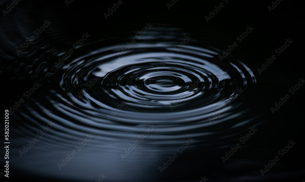 Ripple of water or water drop splash on black background. Abstract ...