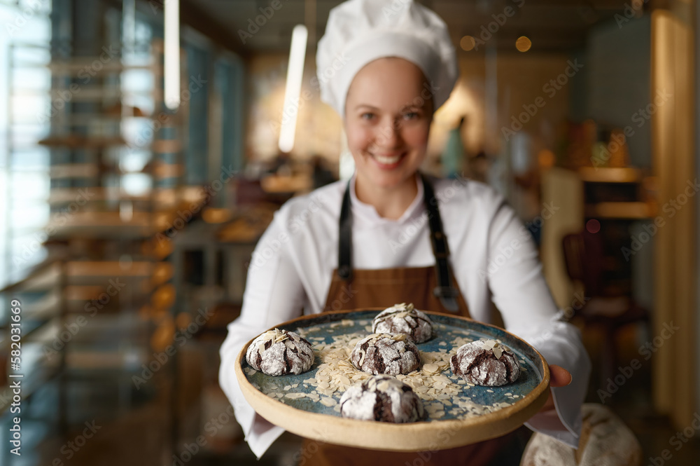 Pastry chef presenting freshly baked cookies at bakery kitchen Stock ...