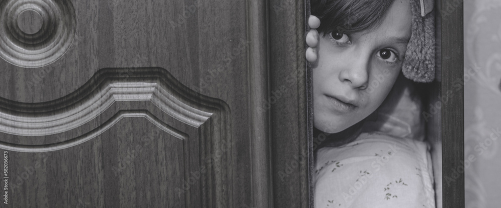 Child scared of nightmare and hiding in closet. Ghost of little girl ...