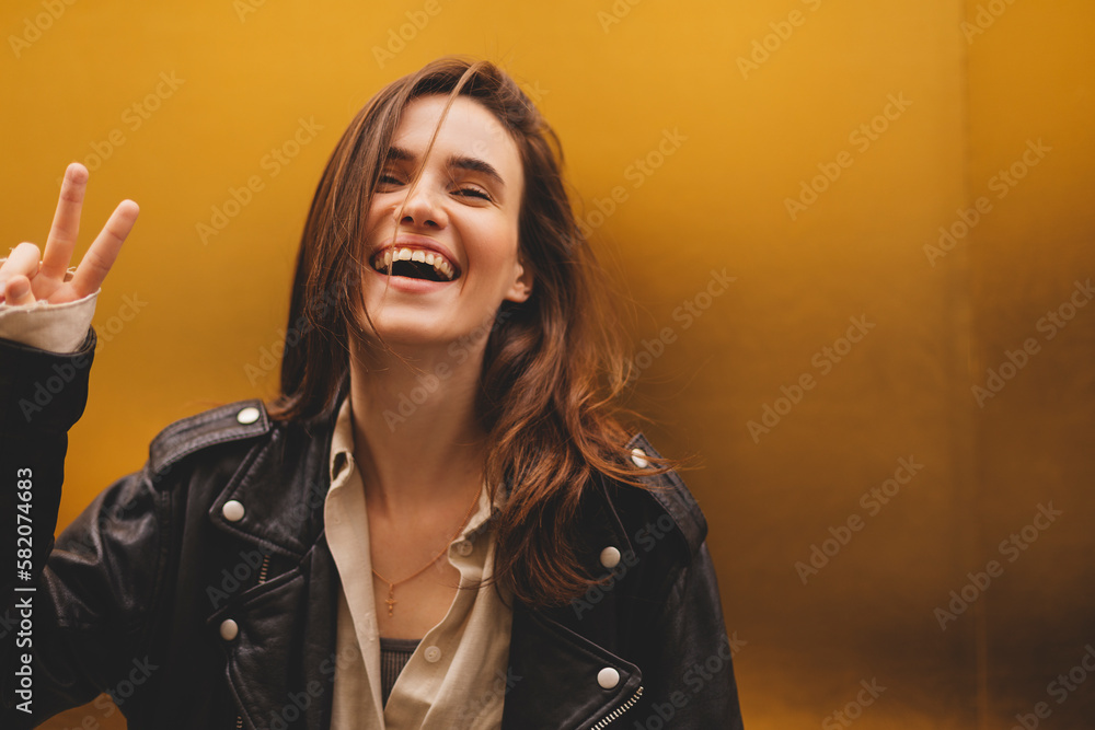 Simpering young brunette woman with a coy smile as she flirts over a ...