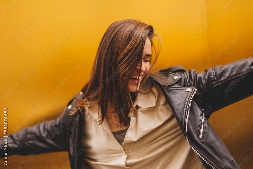 Simpering young brunette woman with a coy smile as she flirts over a ...