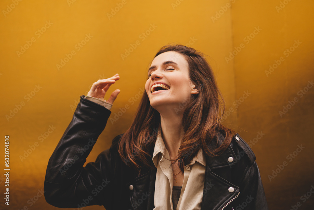 Simpering young brunette woman with a coy smile as she flirts over a ...