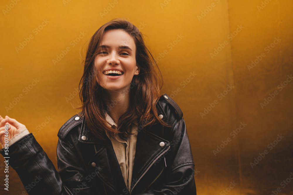 Simpering young brunette woman with a coy smile as she flirts over a ...