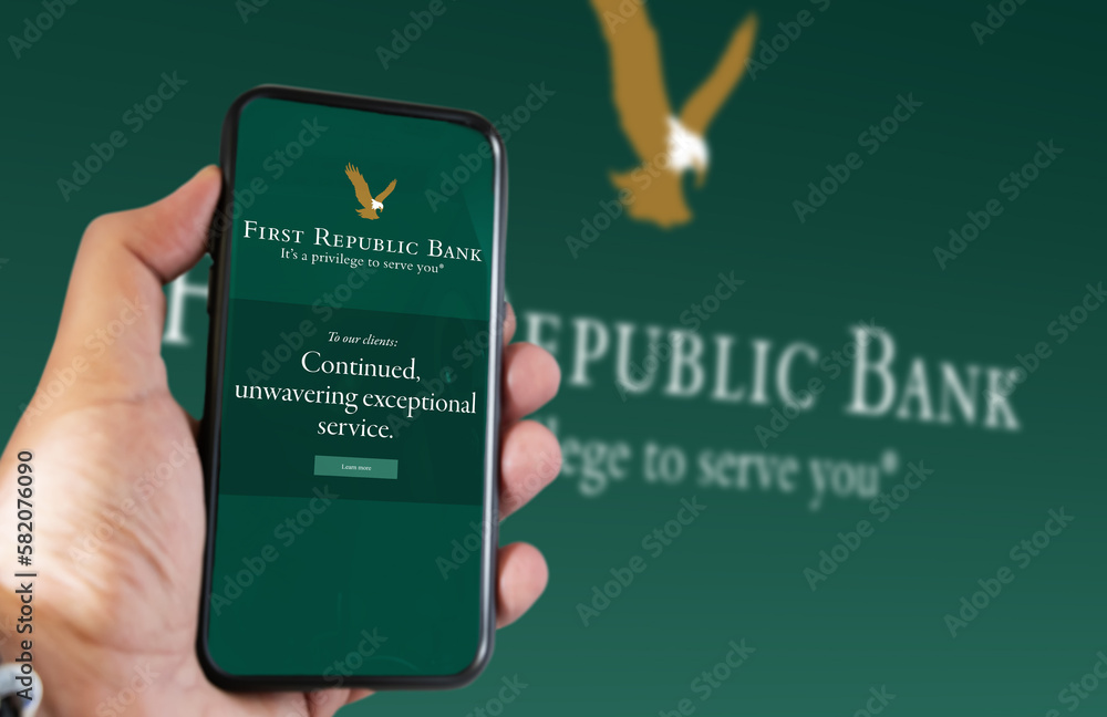 Hand holding a phone with the First Republic Bank logo on the screen ...