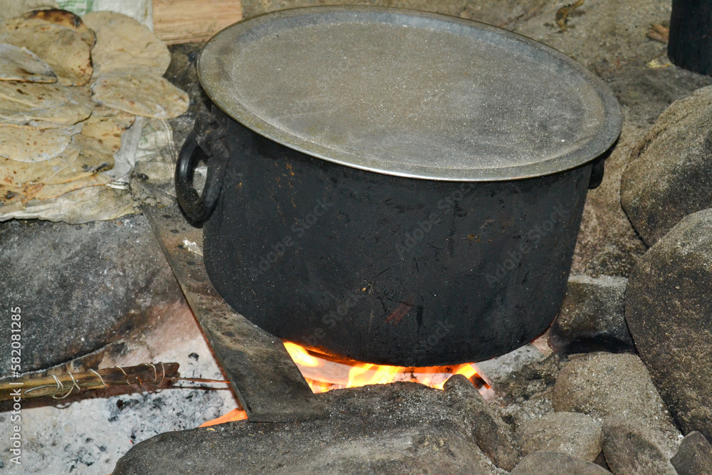 Traditional way of cooking in India. Preparing food in open fire in the ...