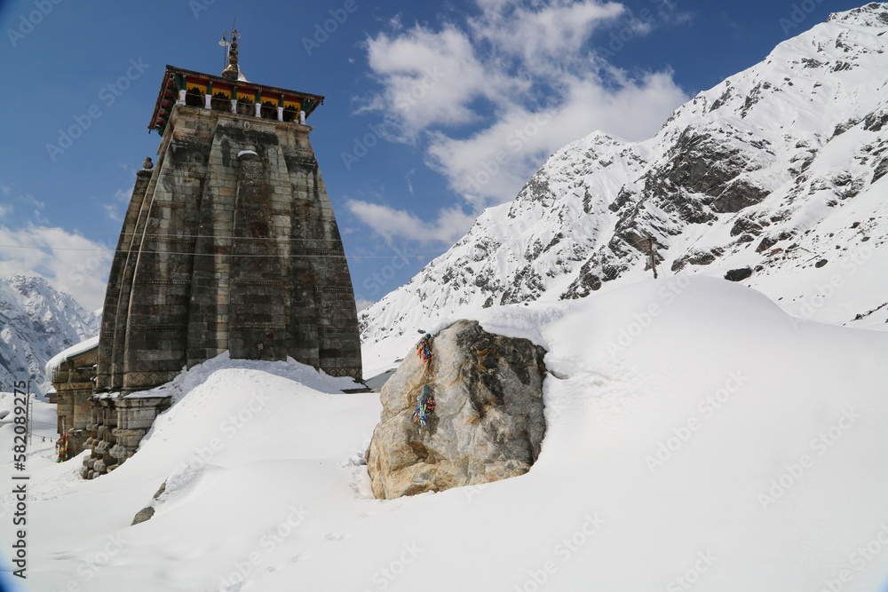 Kedarnath temple, shrine covered with snow. Kedarnath temple is a Hindu ...