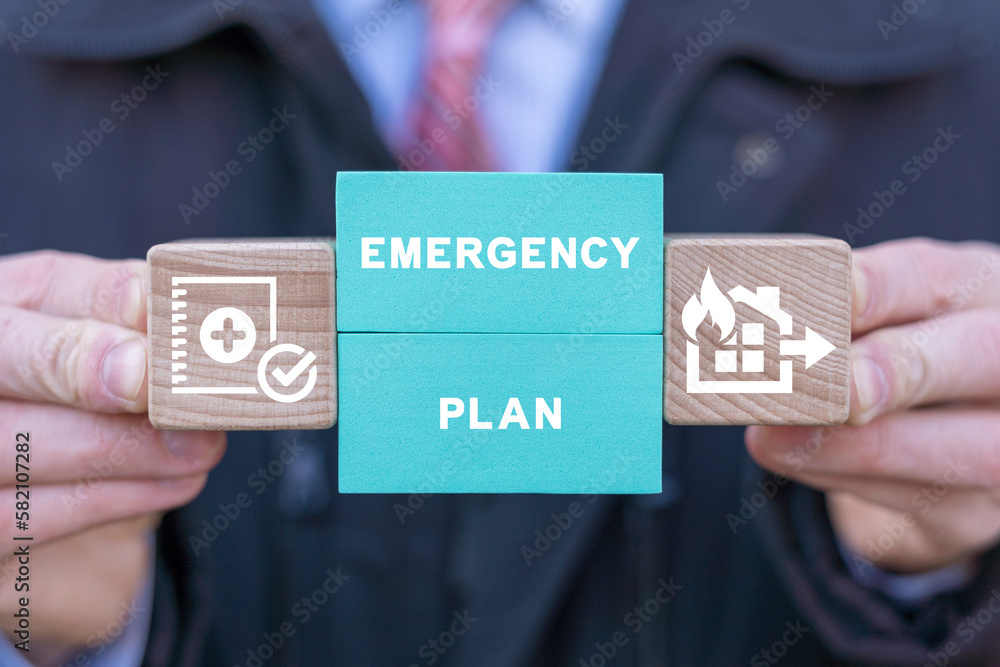 Man holding colorful blocks with icons and inscription: EMERGENCY PLAN ...