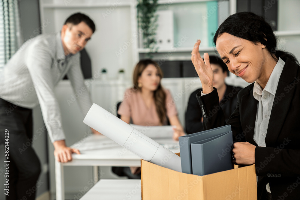 An emotional image of a fired employee packing up her possessions for ...