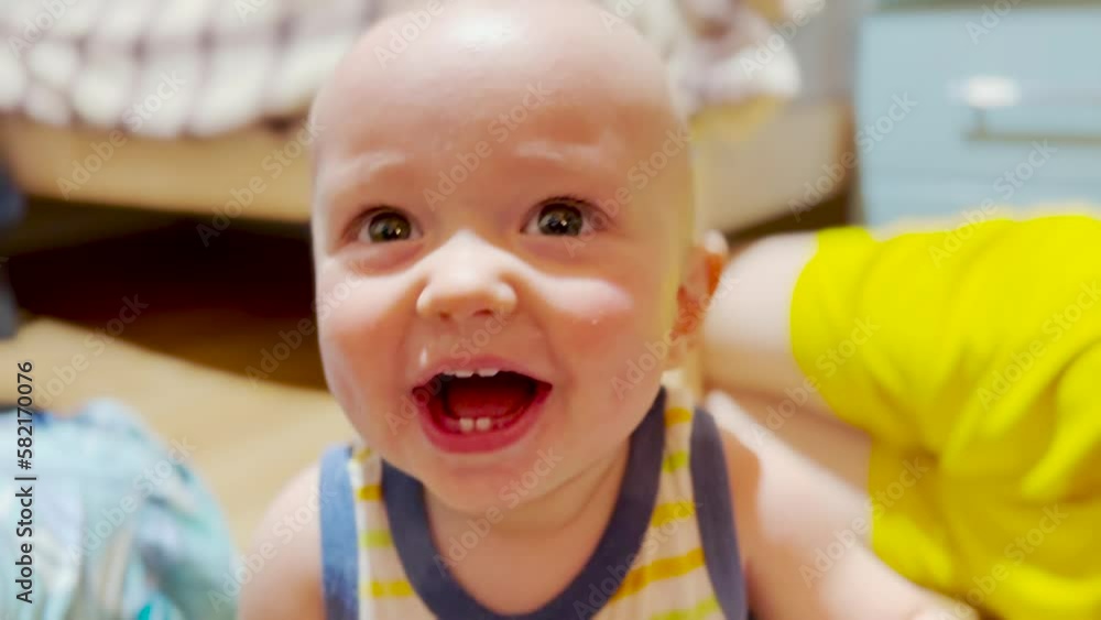 baby boy sitting on the floor laughing. happy family kid dream concept ...