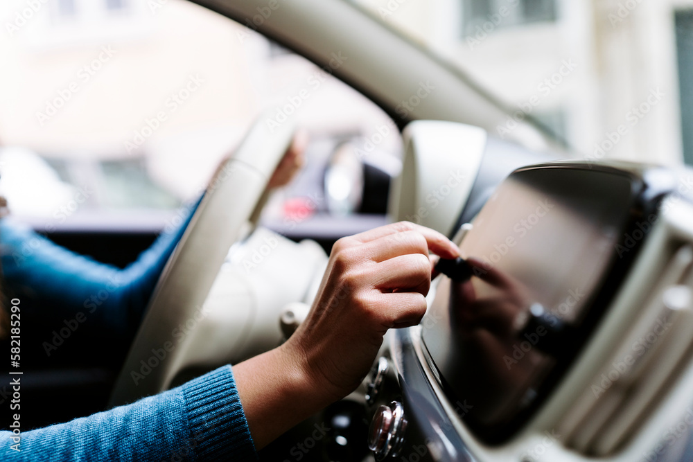Anonymous woman driving car and using dashboard Stock Photo | Adobe Stock