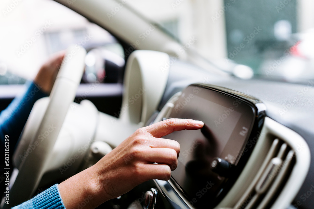Anonymous woman driving car and using dashboard Stock Photo | Adobe Stock