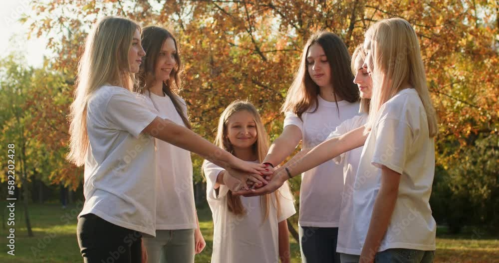 Group of teenage girls put palms of hands together demonstrating strong ...
