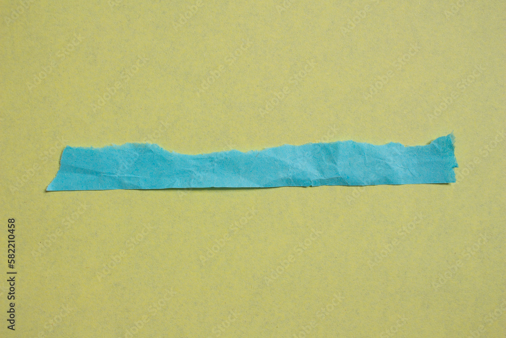 Creased blue paper piece on a yellow background. Crumpled torn paper ...