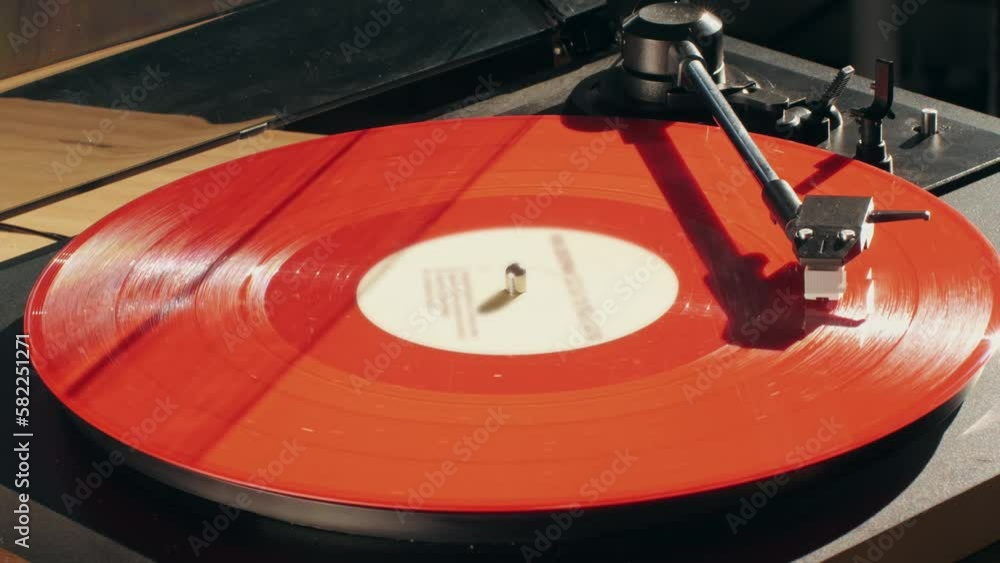 Retro Vinyl red record player playing music, close-up macro shot of ...
