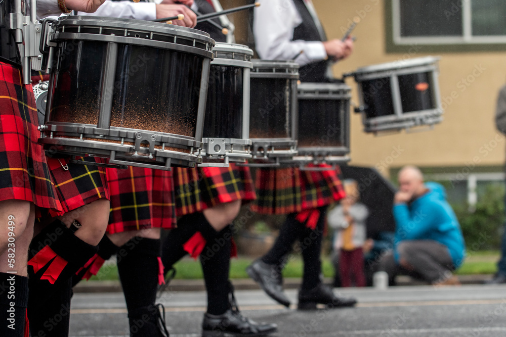 Scottish marching band drumline wearing traditional kilts and kilt hose ...