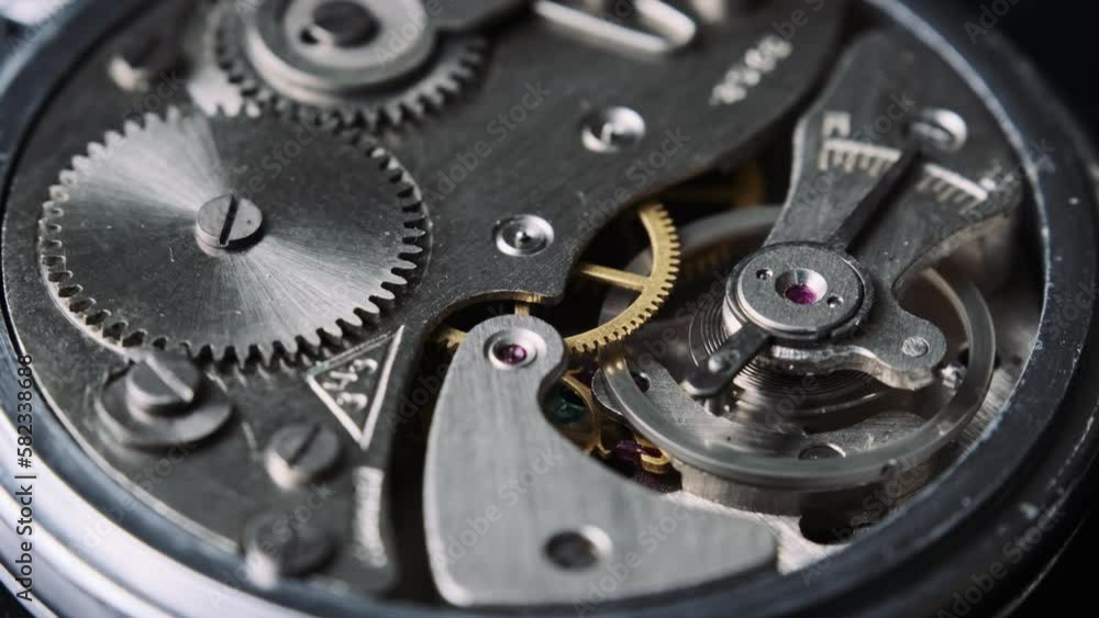 The mechanism of vintage stopwatch rotates close-up. Round clock watch ...
