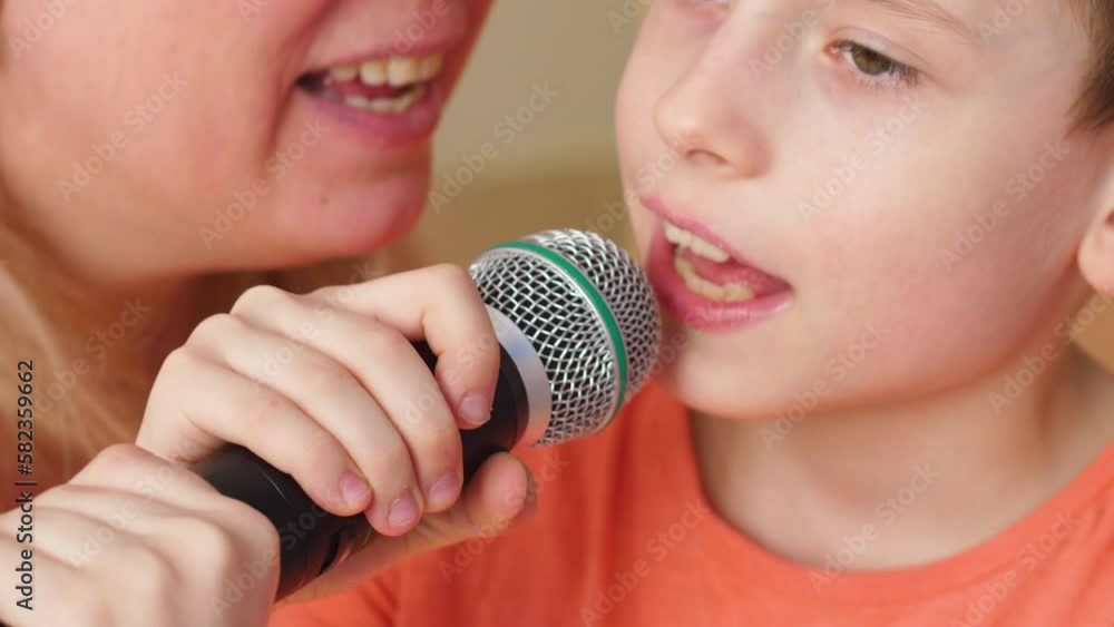 portrait of a vocal teacher and a caucasian boy 8 years old singing ...