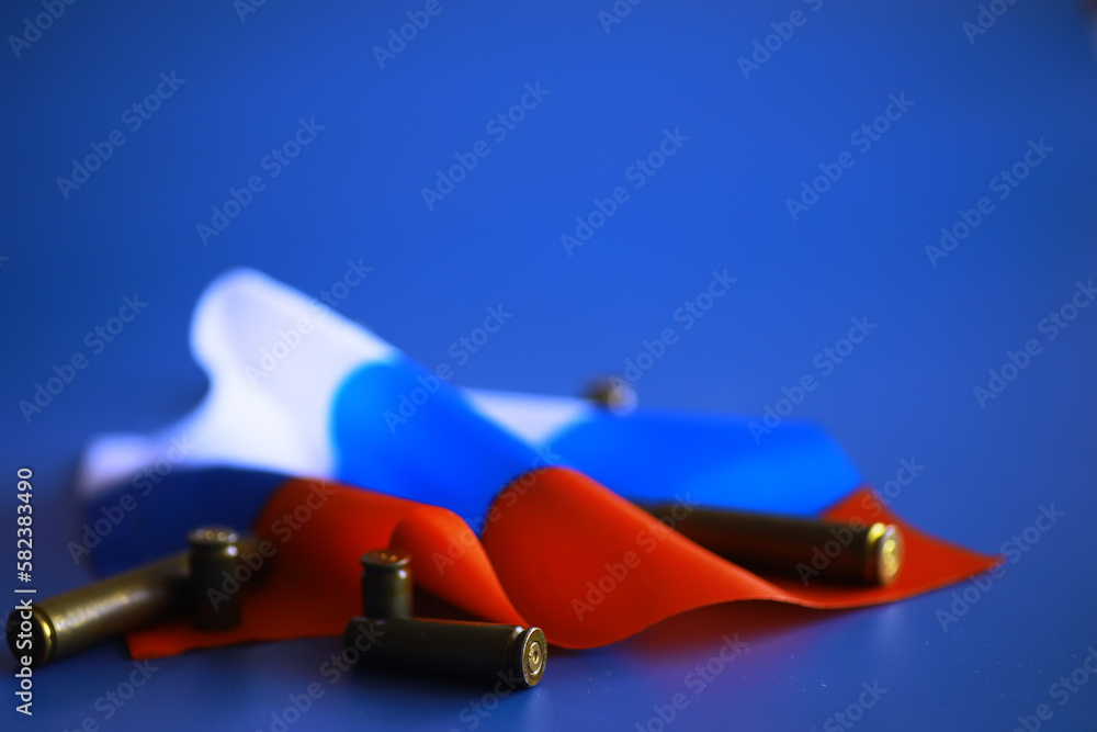Russian flag and bullet casings on the table. Background concept ...